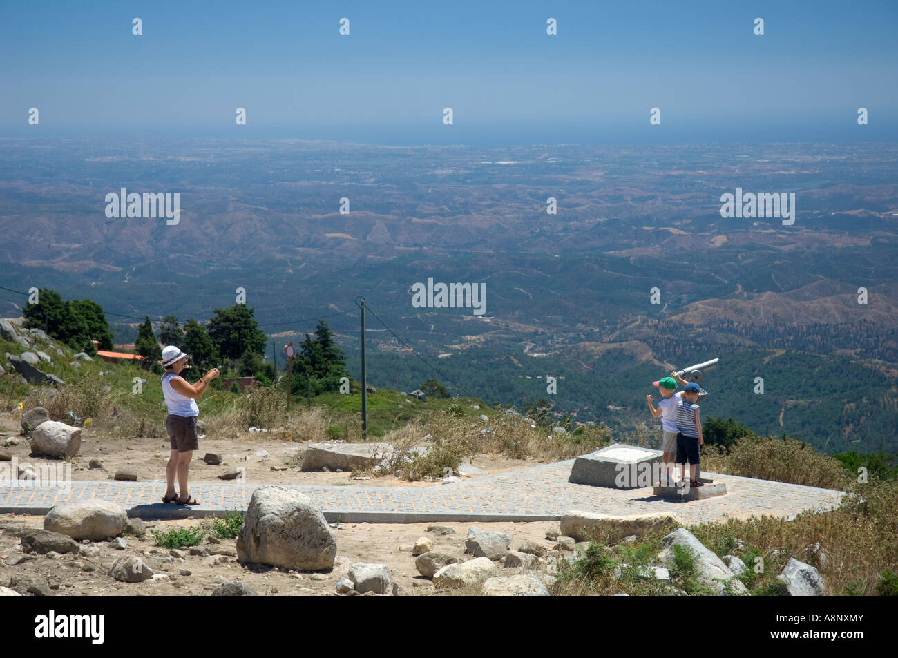 A woman takes photographs of her two children on the summit of Mount ...