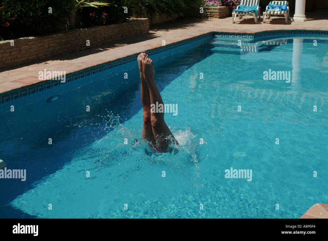 Woman diving into a pool on holiday in a villa Stock Photo - Alamy