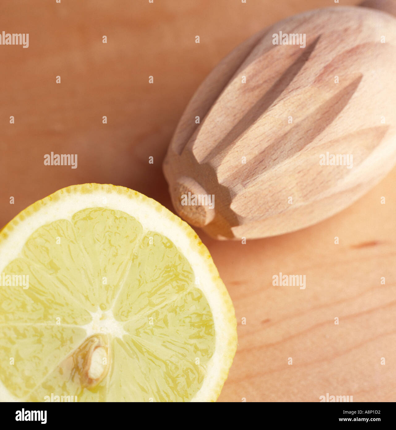 Wooden lemon sq ueezer and lemon slice on a wood background Stock Photo ...