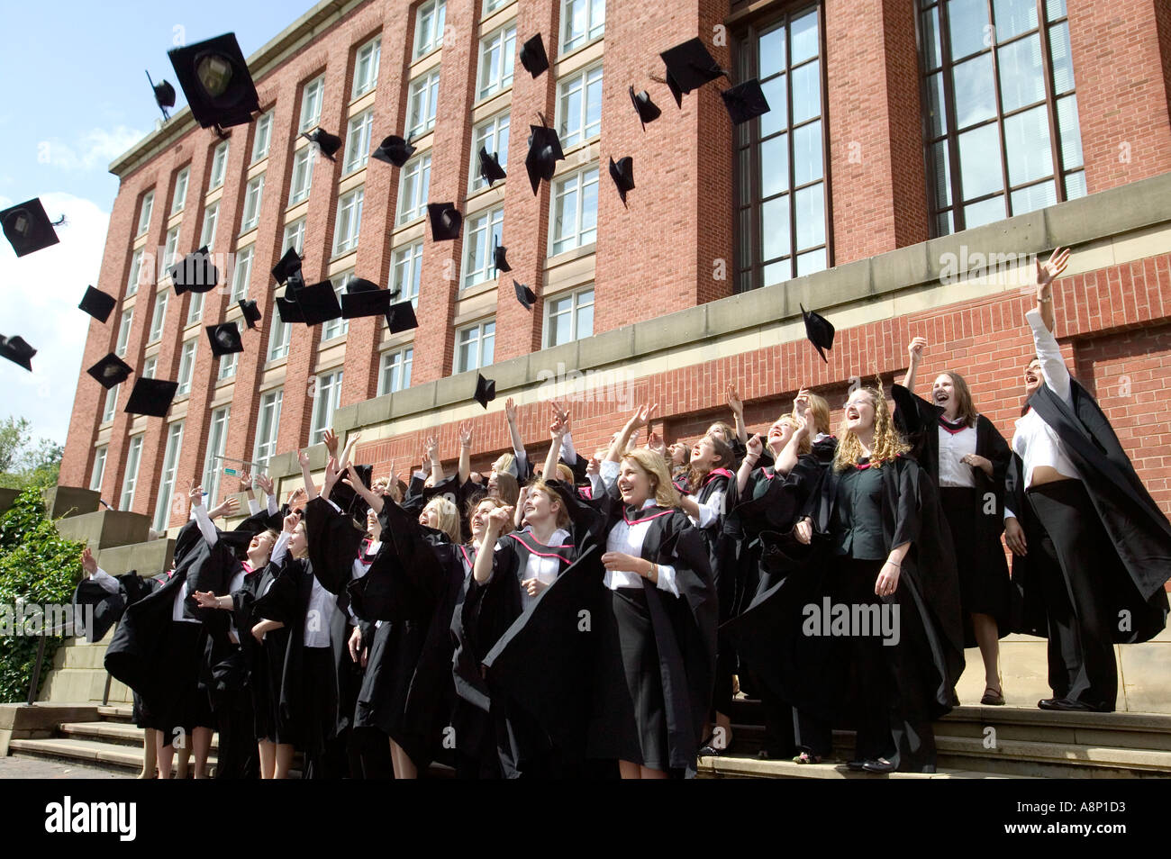Graduates cheer for a photograph after a degree ceremony at Birmingham ...