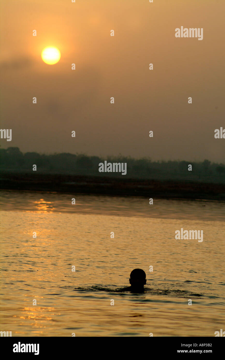 EARLY MORNING SWIM IN GANGES Stock Photo - Alamy