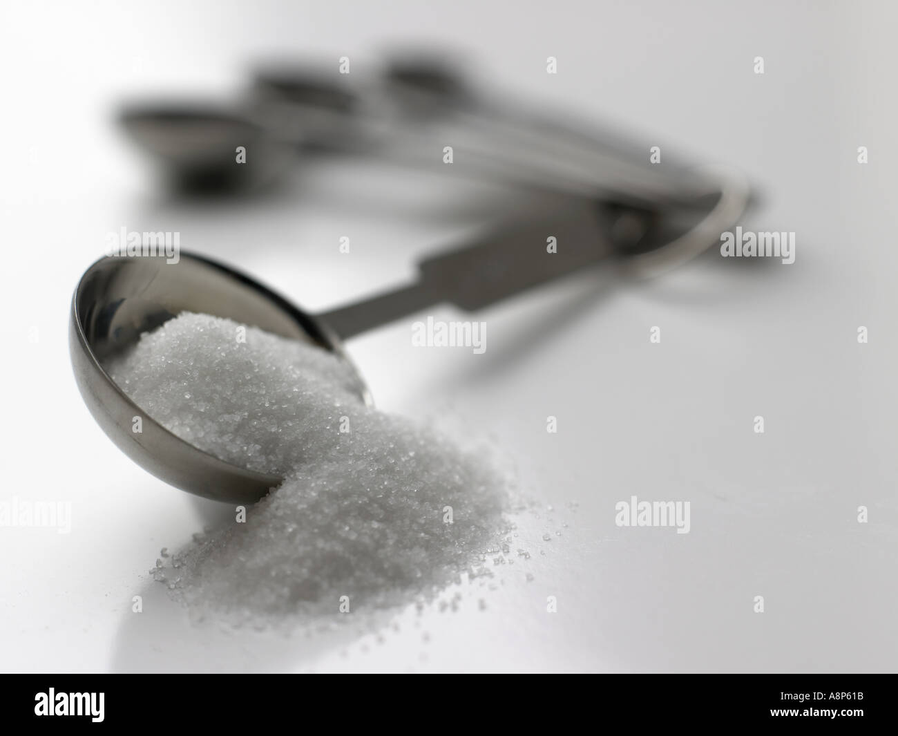 measuring spoons with white sugar Stock Photo - Alamy