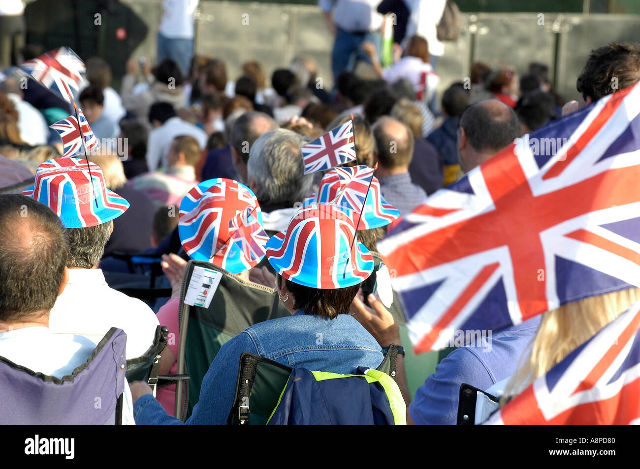 Fans at an outdoor concert in Hyde Park London with Union Jack flags ...