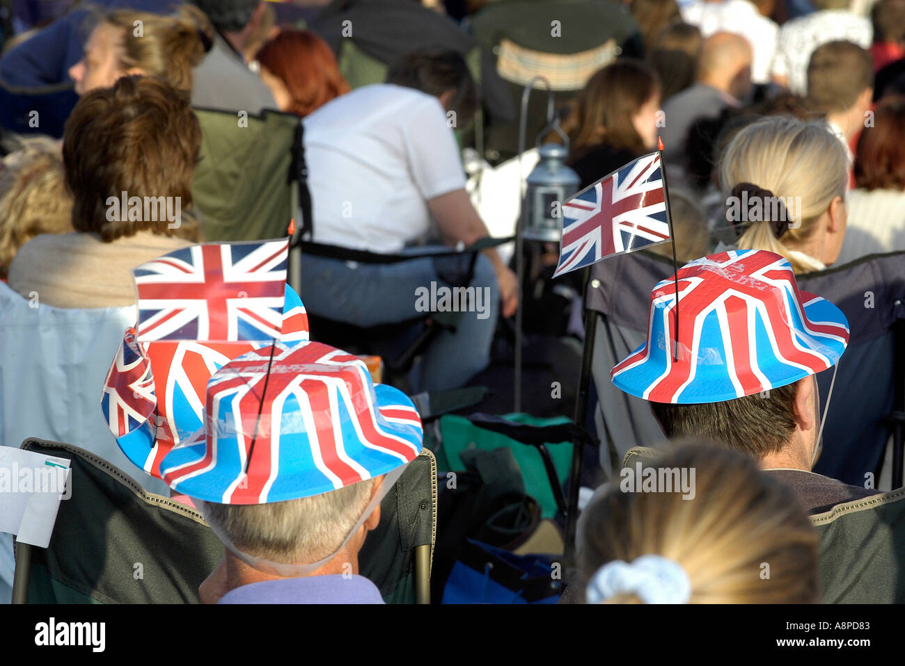 Fans at an outdoor concert in Hyde Park London with Union Jack flags ...