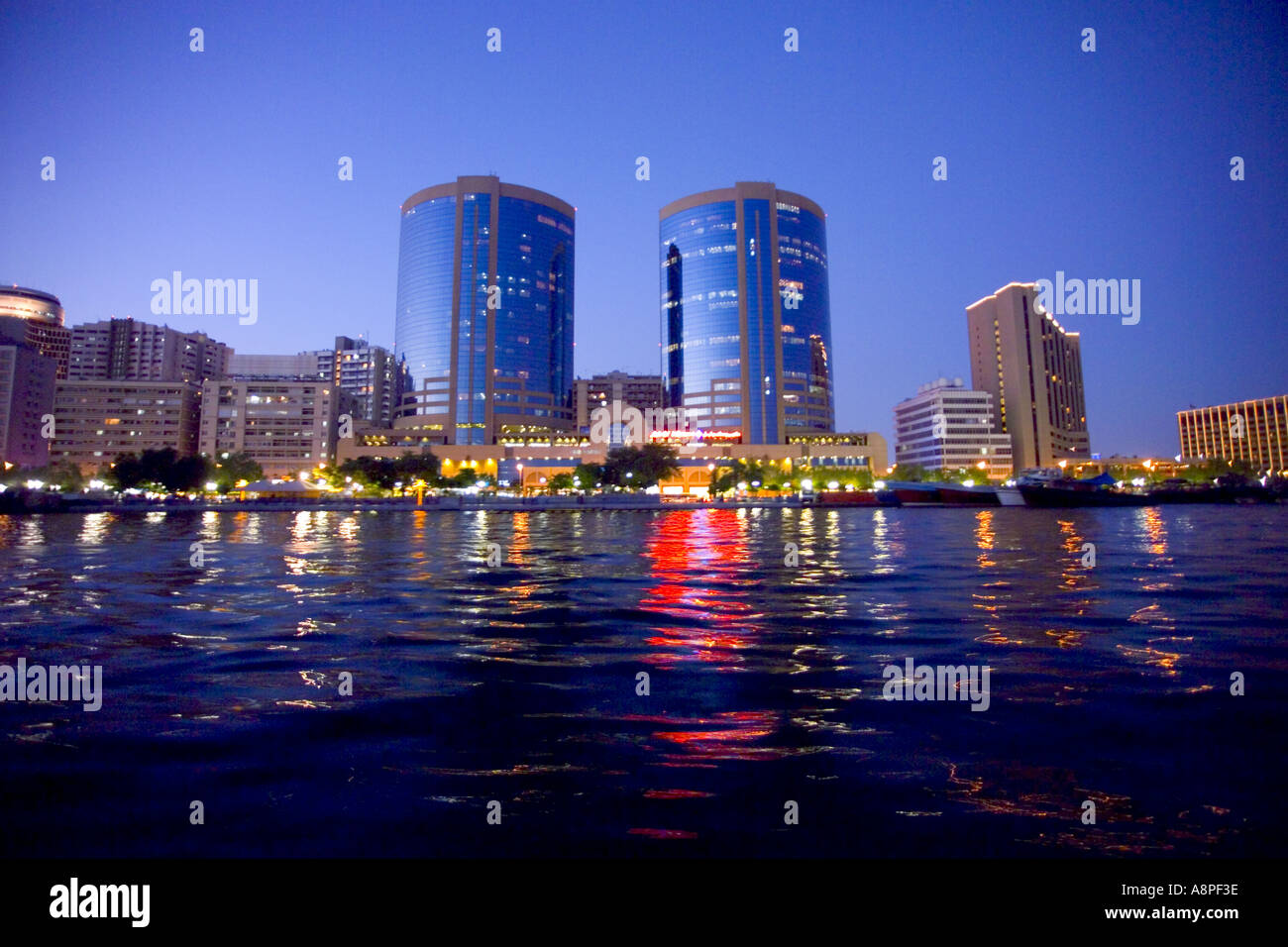Dubai United Arab Emirates Rolex Twin Towers on Dubai Creek at dusk ...