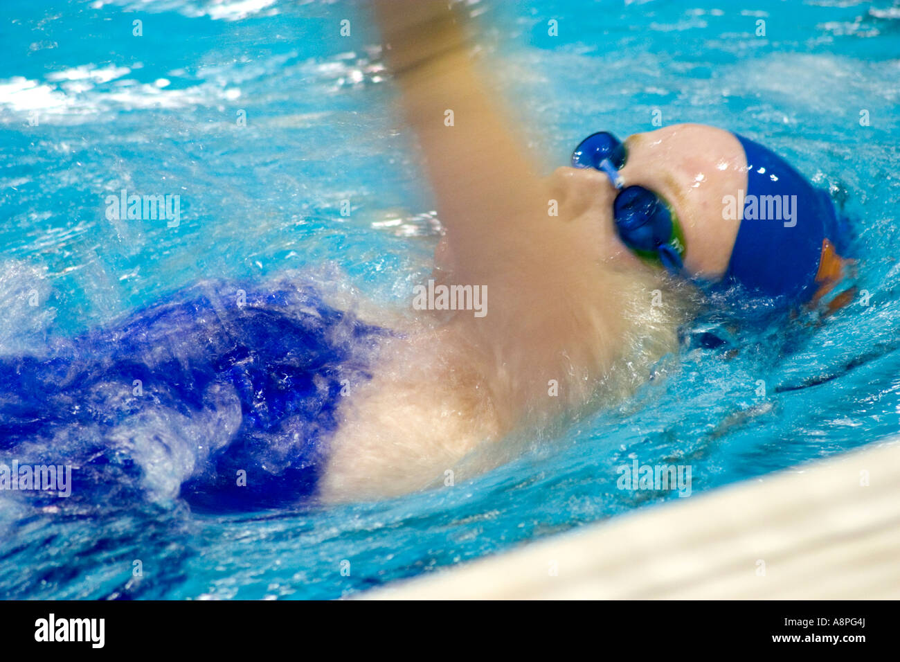 College woman competitor swimming the backstroke blur. Macalester ...