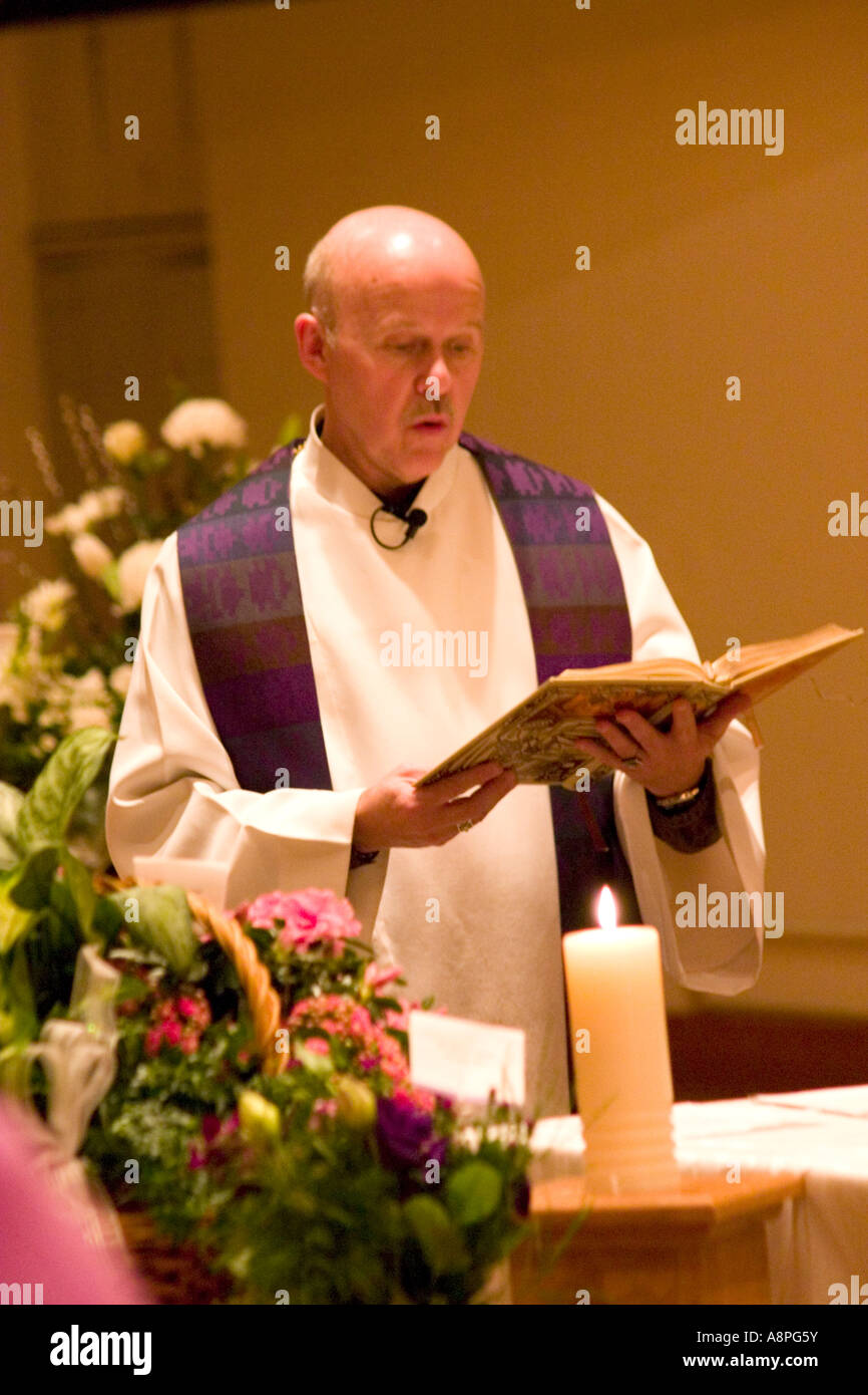 Priest conducting a funeral service. St Joan of Arc Catholic Church ...