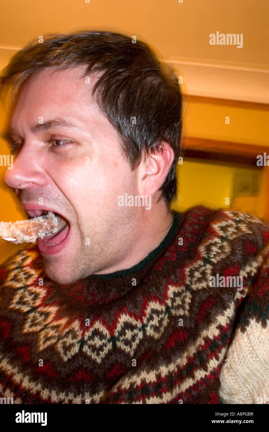 Hungry man taking a big bite of dinner. St Paul Minnesota USA Stock ...