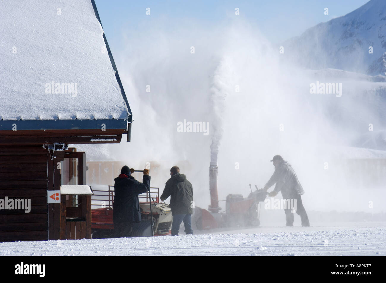 snow blower clearing deep snow outside building Stock Photo - Alamy