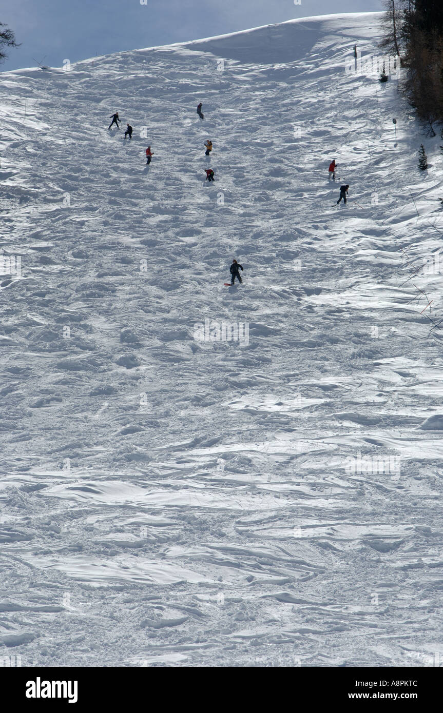 Skiers descending a black run Stock Photo - Alamy