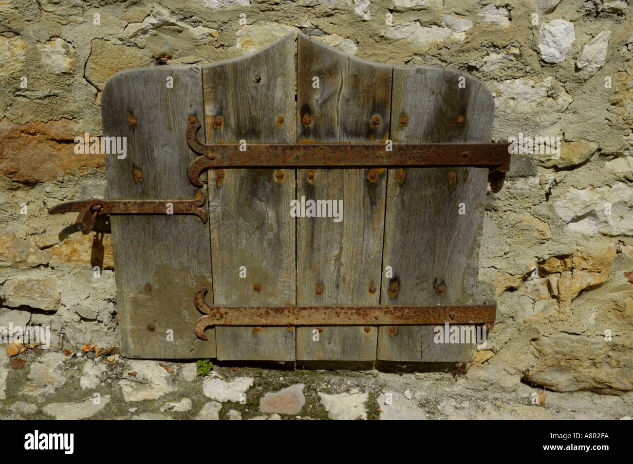 Wooden shutter over window in a stone wall in the Lot France Stock ...