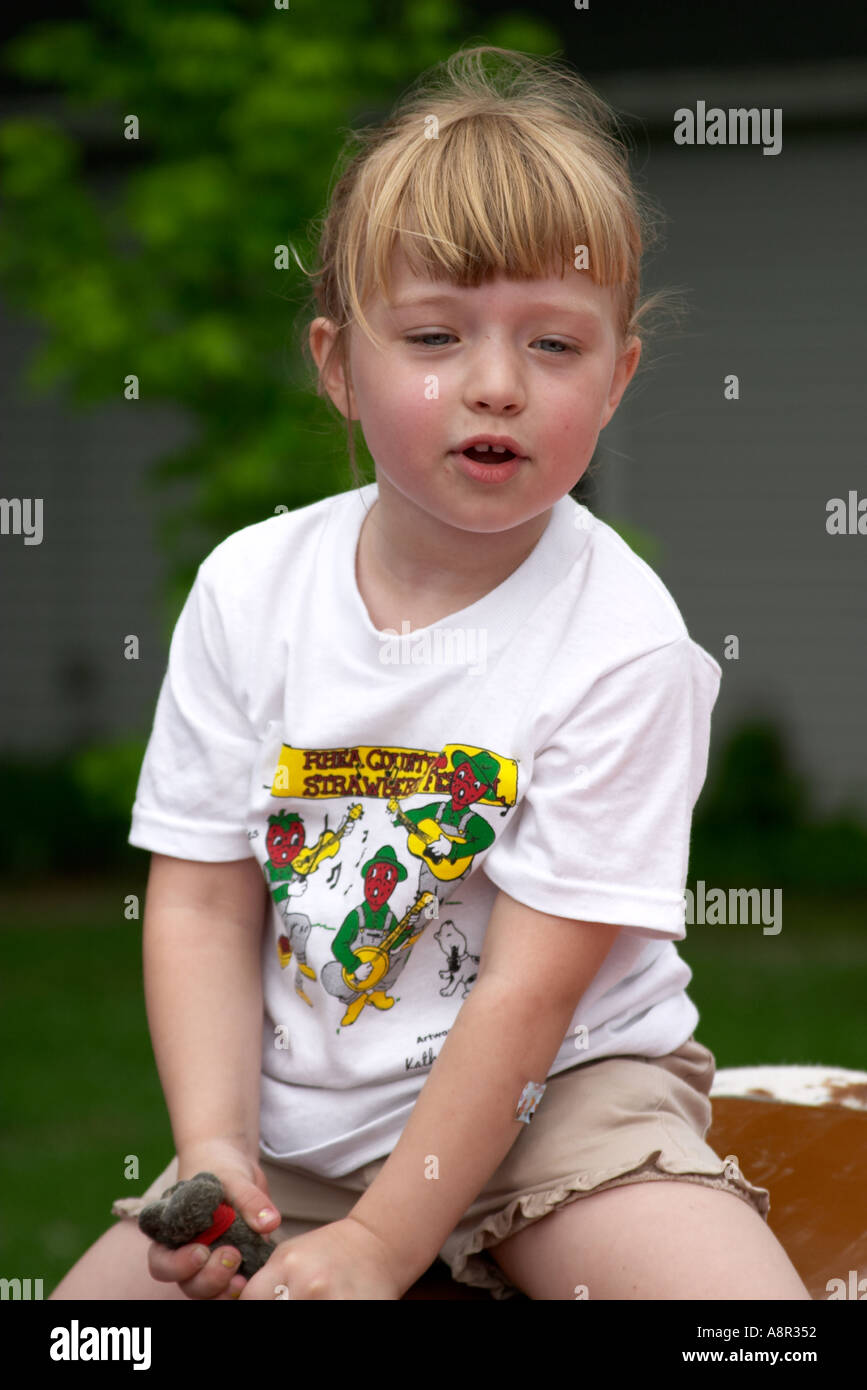 A little girl riding a mechanical bull at the East Tennessee Strawberry ...