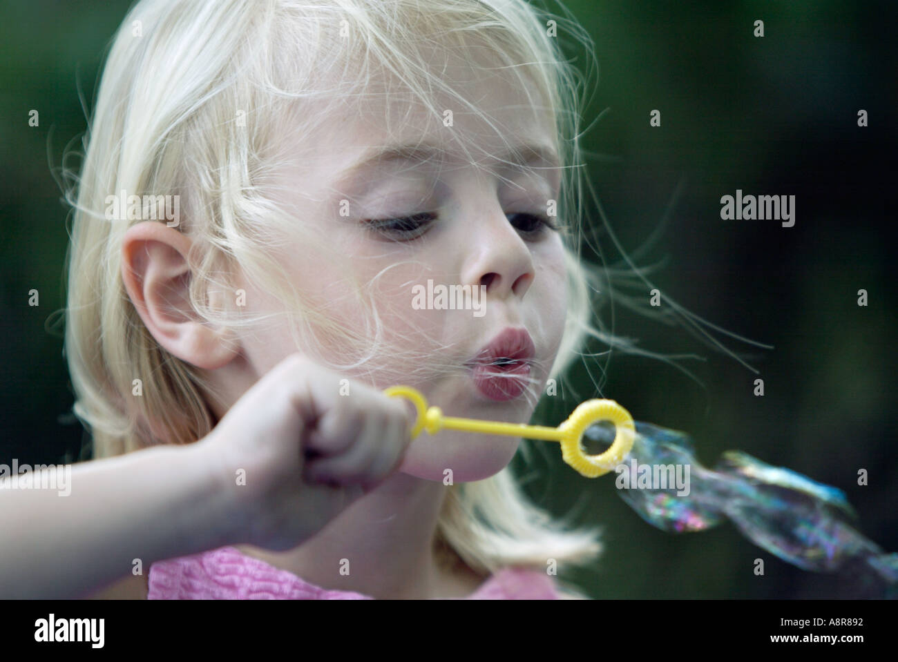 Young child blowing bubbles Stock Photo - Alamy