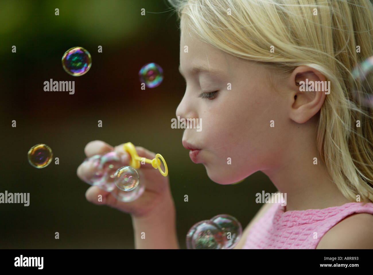 Young child blowing bubbles Stock Photo - Alamy