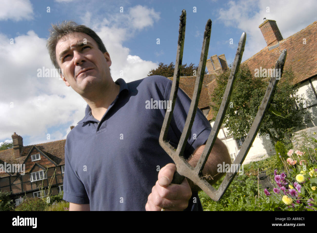 Market gardener holding garden fork Stock Photo - Alamy