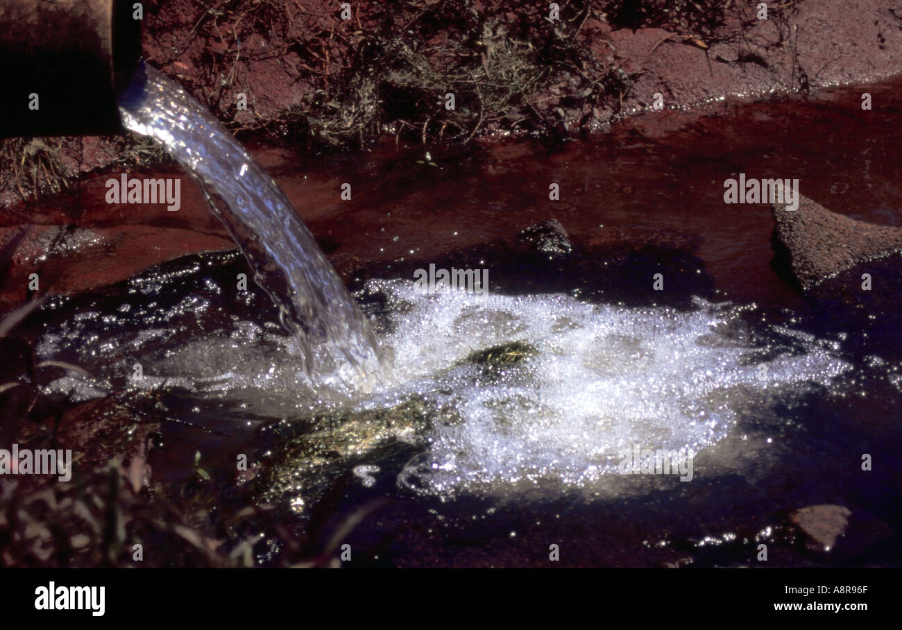 Water pouring into dam from pipe Stock Photo - Alamy