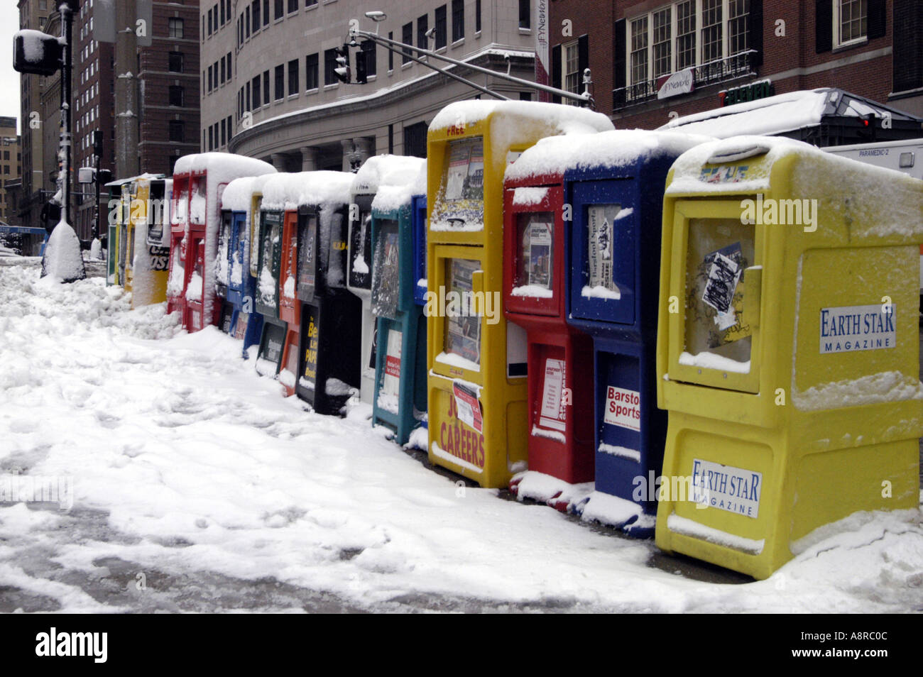 Row of newspaper selling boxes on street corner in snow Stock Photo - Alamy