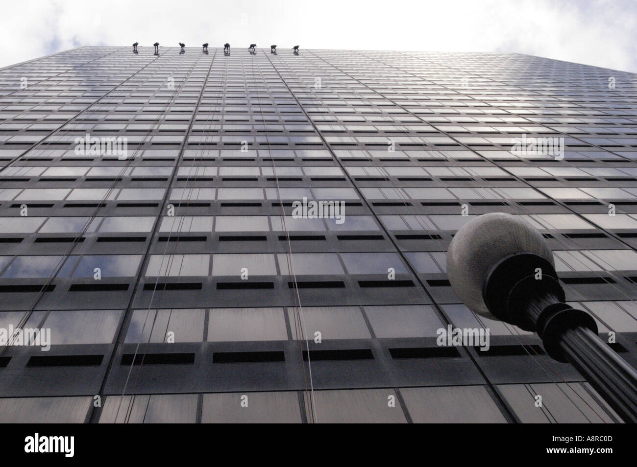Rope suspended window washers on high office building Stock Photo - Alamy