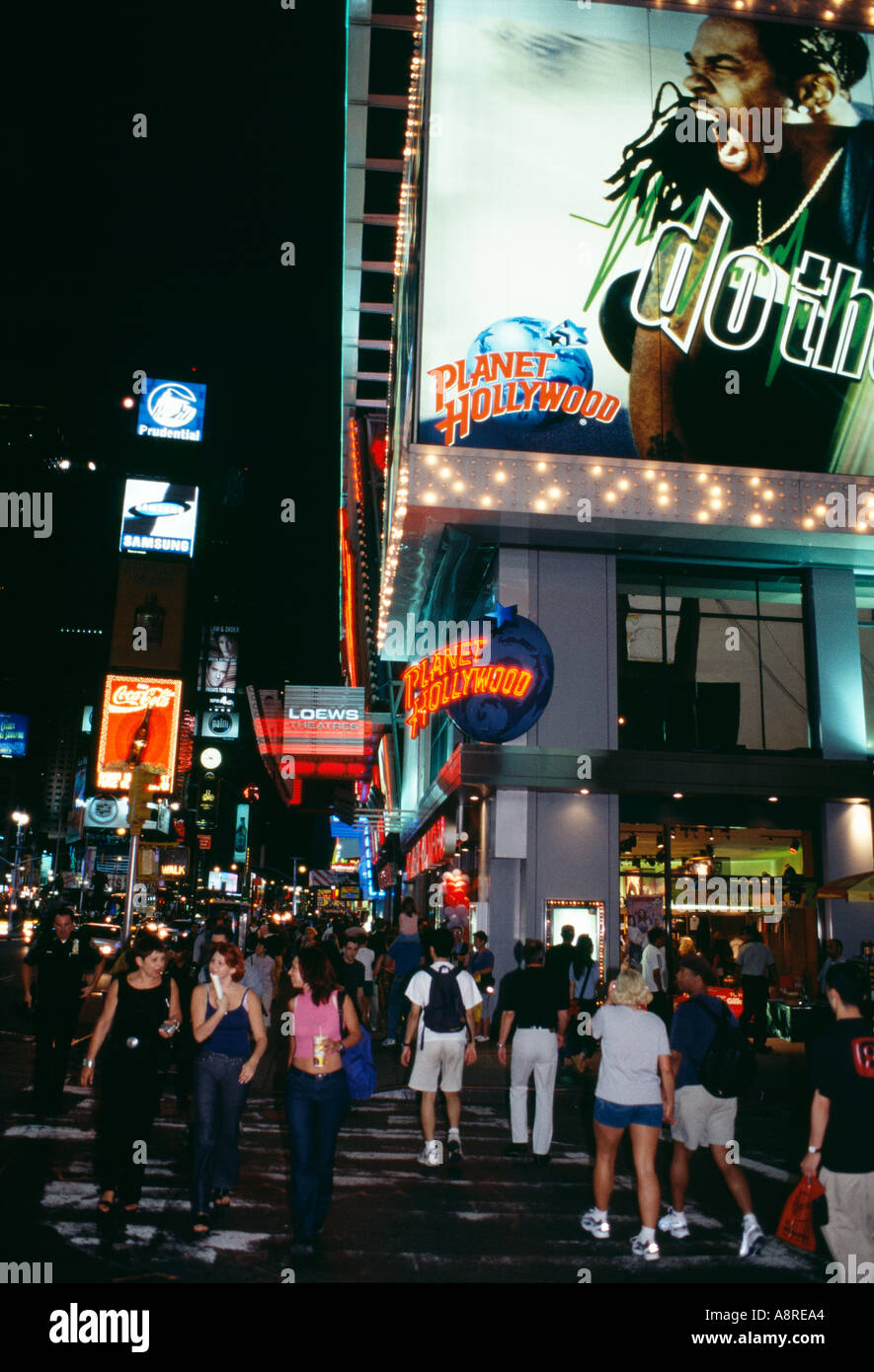 Busy street scene and neon lights at night in Times Square New York USA ...