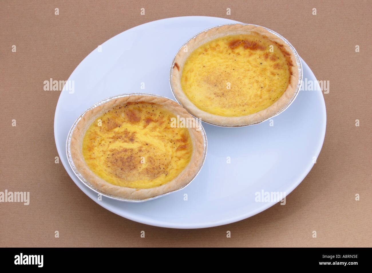 custard tarts still life shot in the studio on a tan background Stock ...