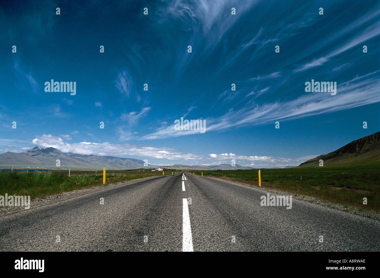 Straight away view of a highway into the distance on a partly cloudy ...