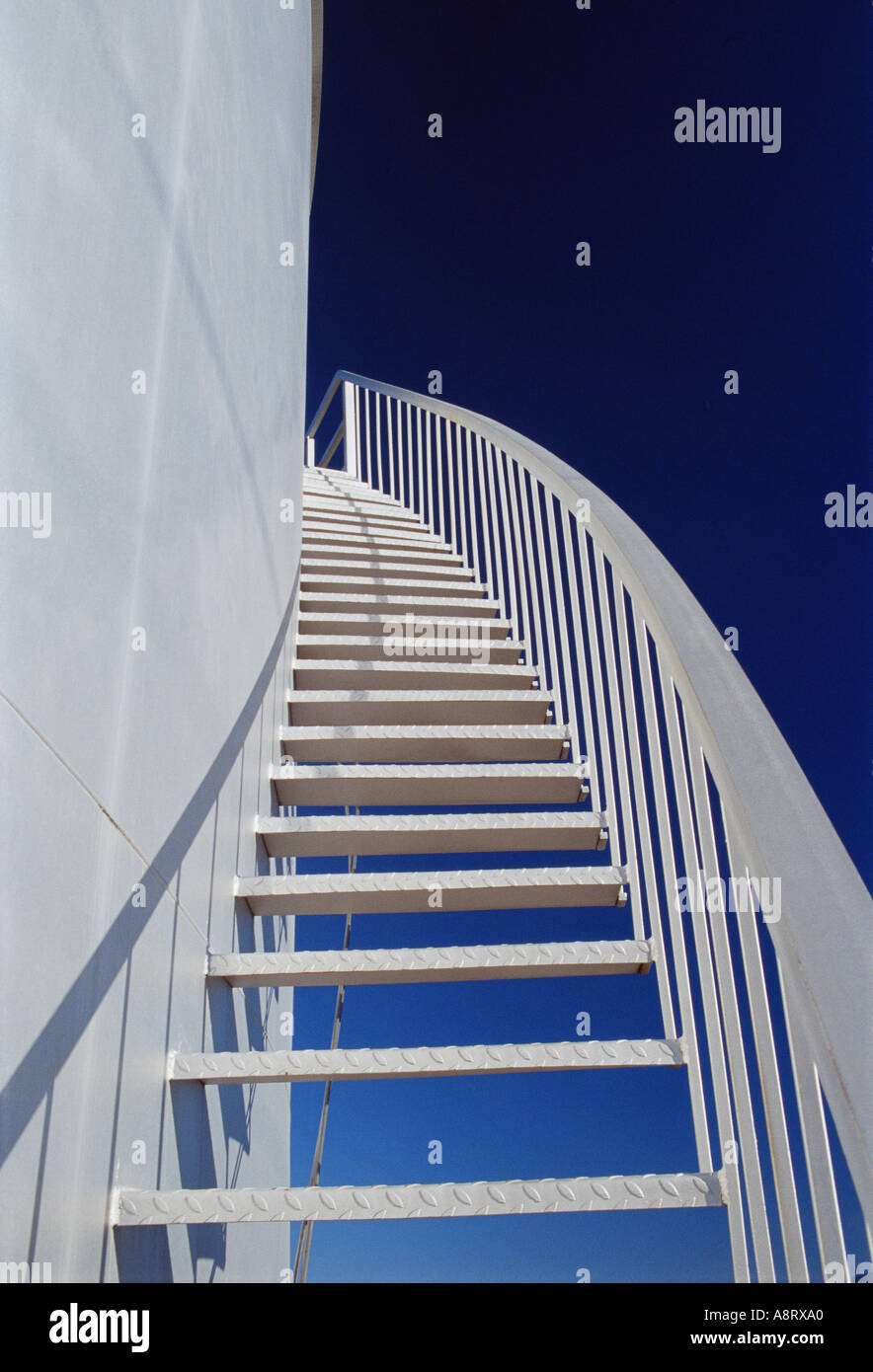 Silver metal steps ascending around the side of a cylinder shaped ...