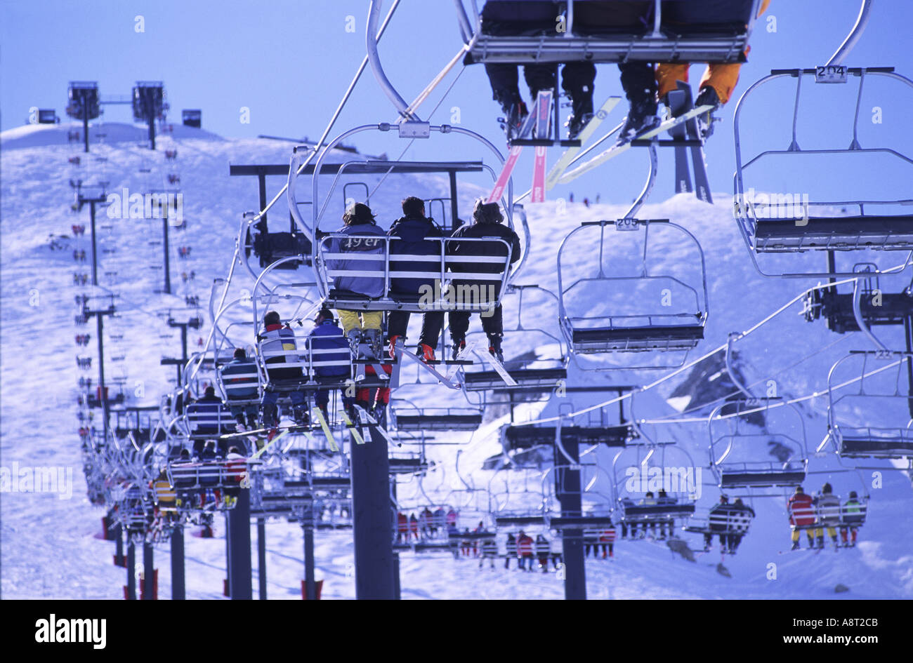 A double chairlift carries skiers to the top of a piste at Vald'Isere ...