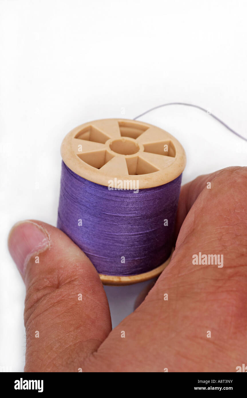 Hand Holding Spool of Dark Lilac Mercerised Cotton Thread Made In ...
