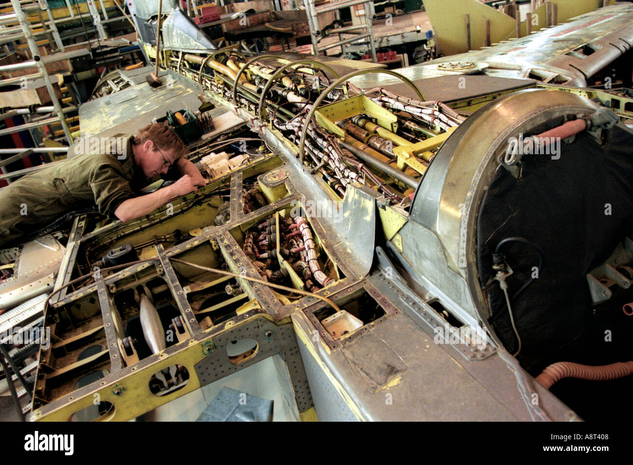 Technicians work on a Tornado GR4 fighter jet in maintenance hanger at ...