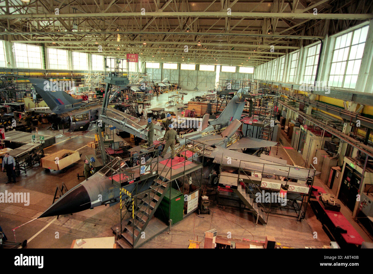 Technicians work on a Tornado GR4 fighter jet in maintenance hanger at ...