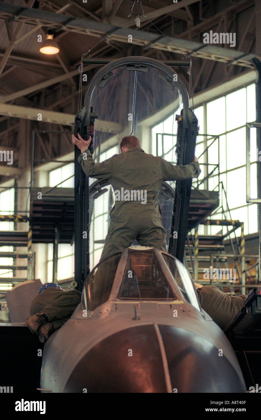Technicians work on a Tornado GR4 fighter jet in maintenance hanger at ...