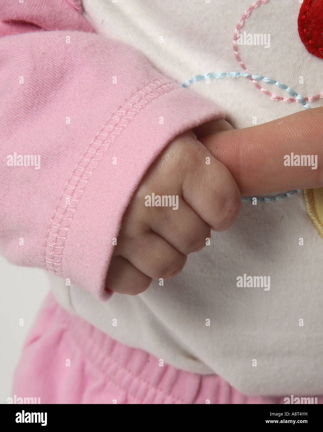 Young child holding finger of parent Stock Photo - Alamy
