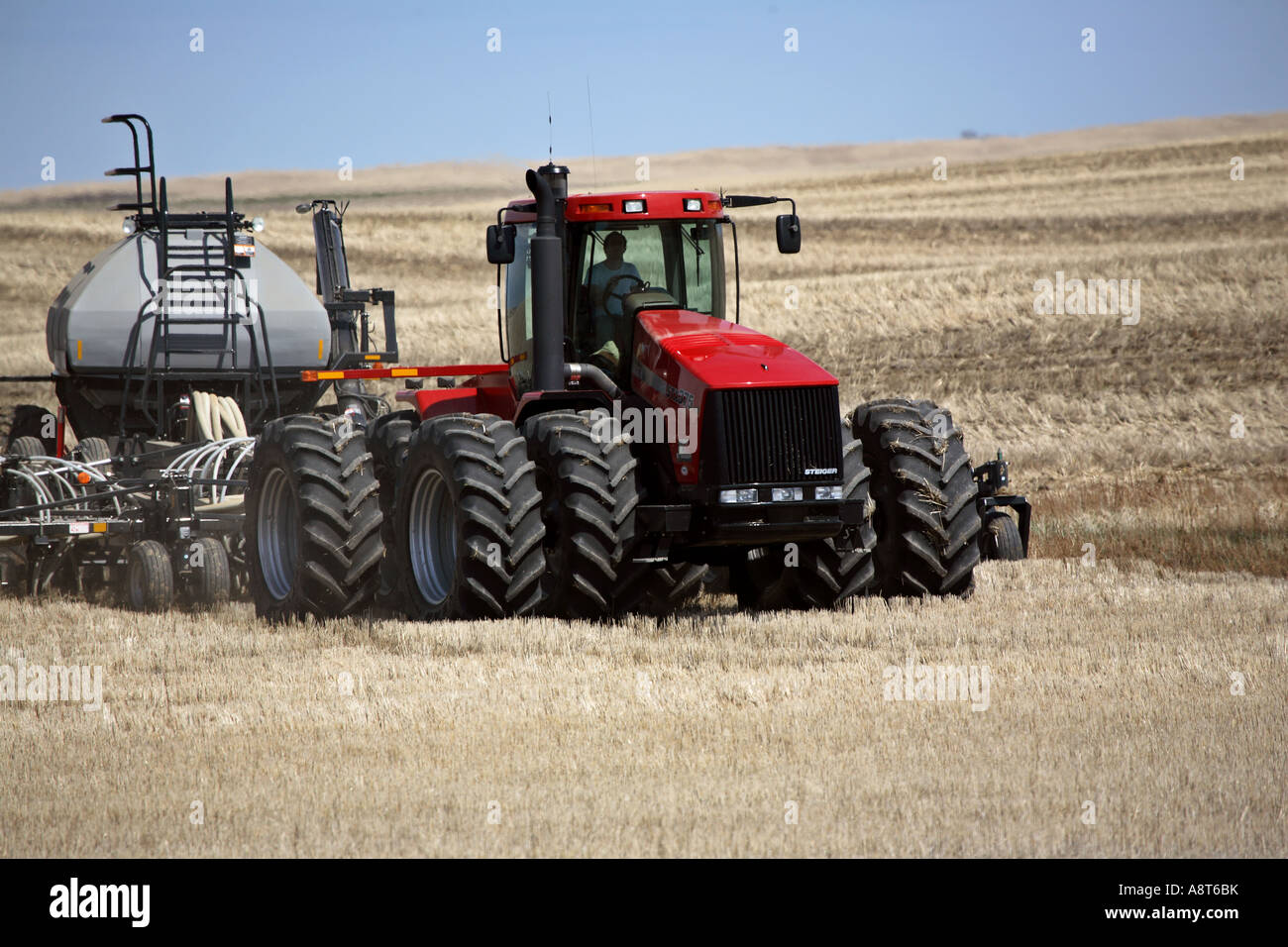 Farmer busy with spring seeding Stock Photo - Alamy