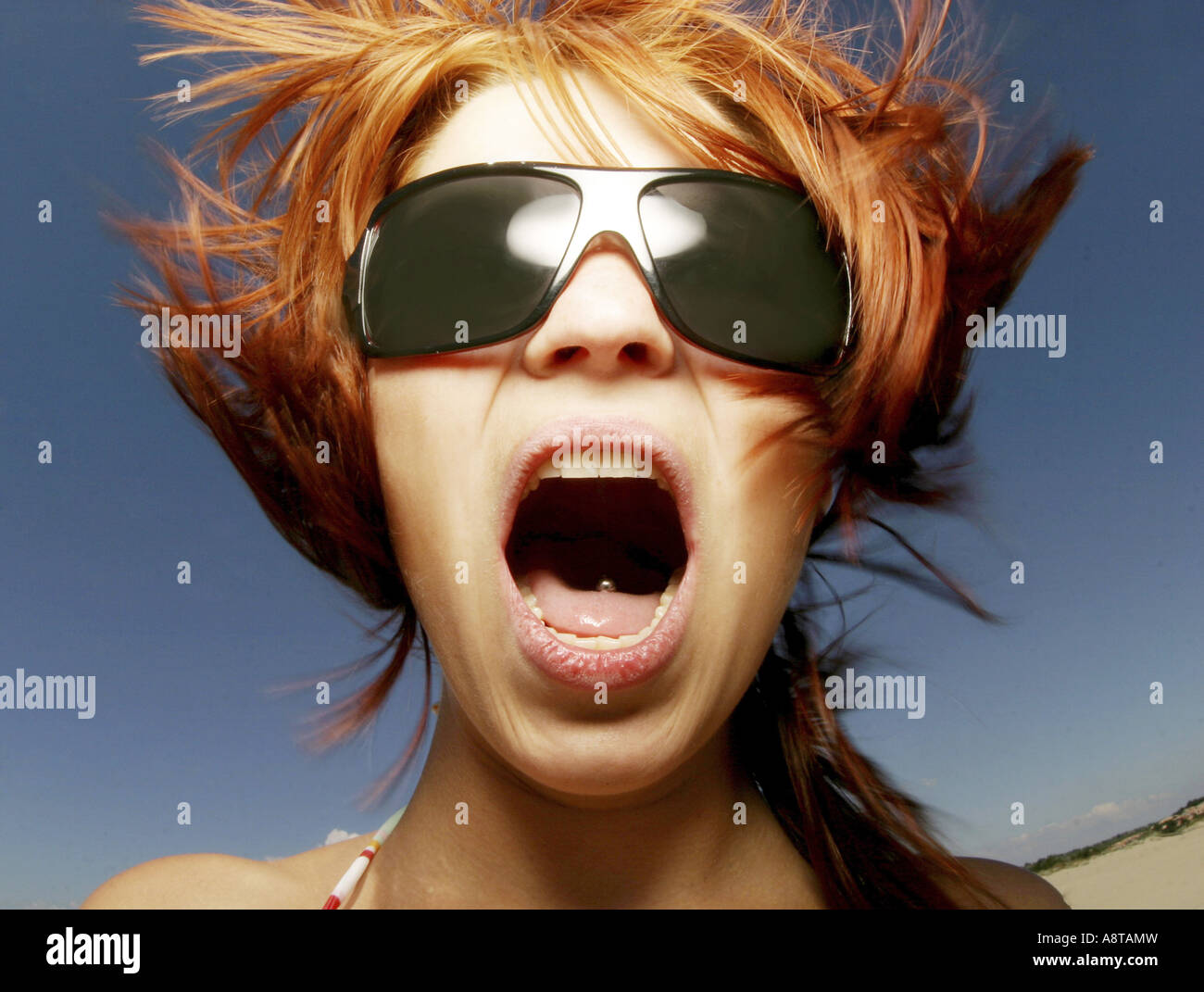 crying redheaded girl with tongue piercing Stock Photo - Alamy