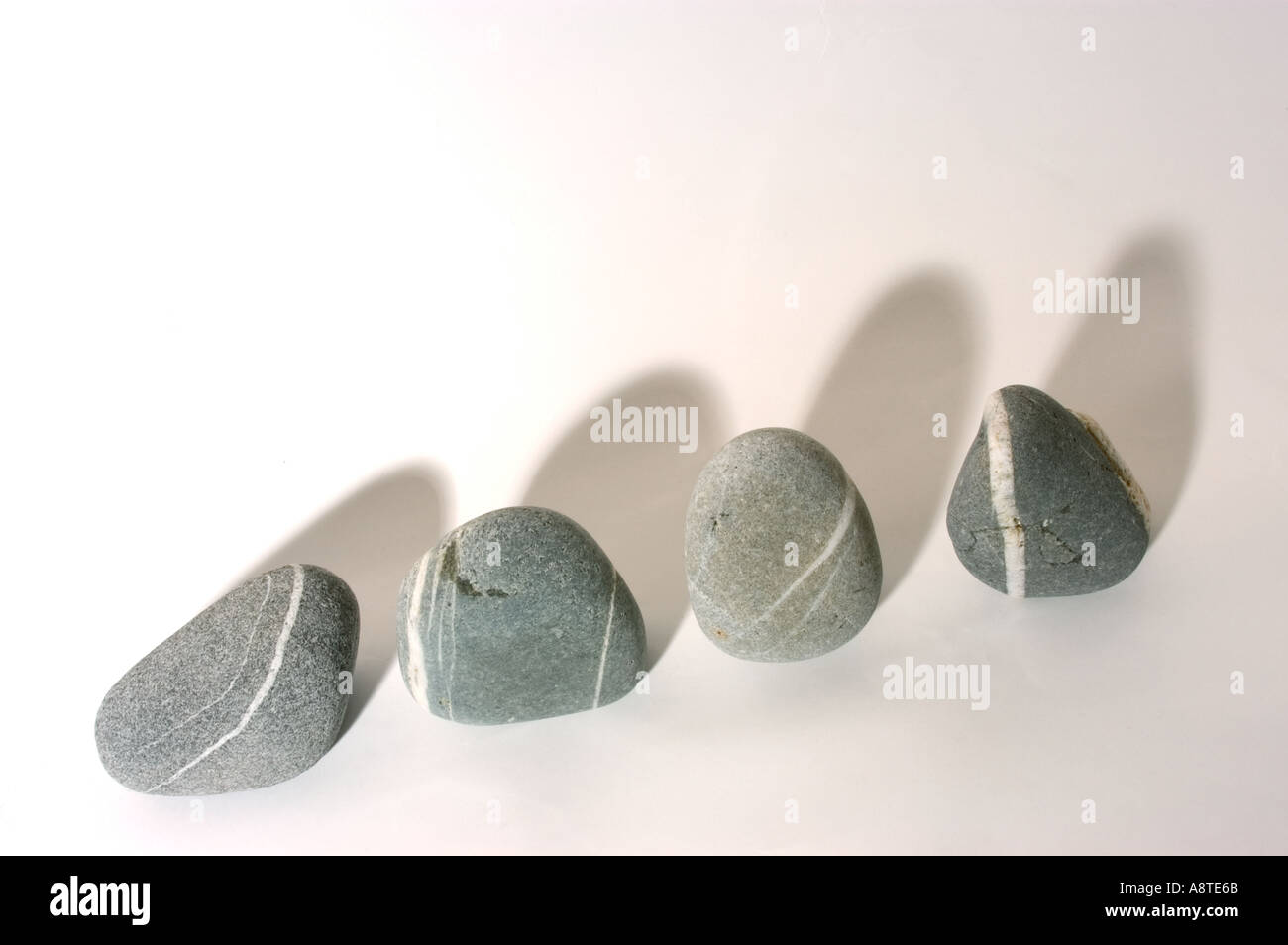 Four Stones with Shadows Stock Photo - Alamy