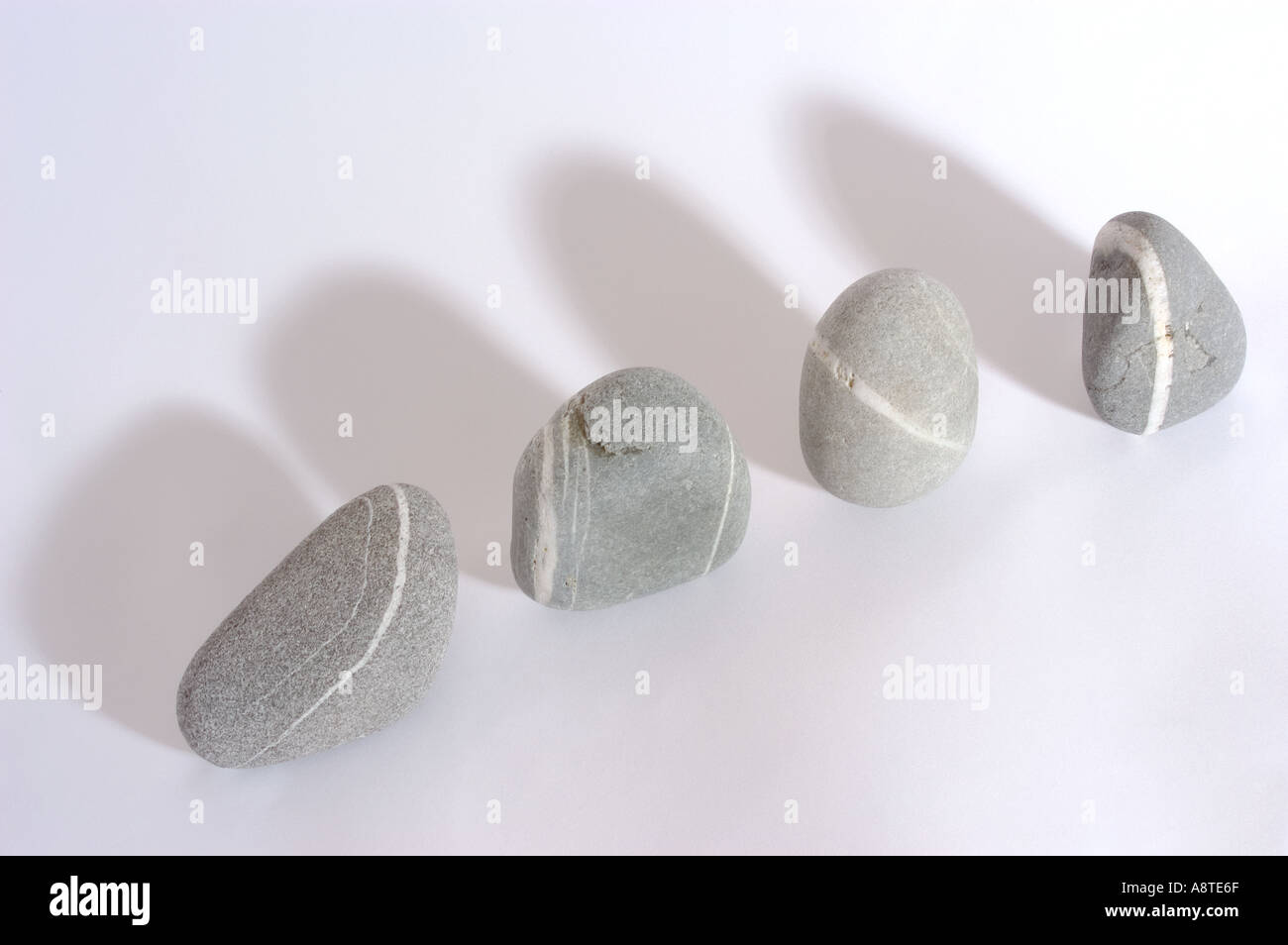 Four Stones with Shadows Stock Photo - Alamy
