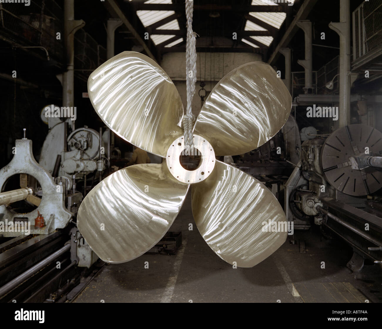 Bronze Ships Propeller hangs by a rope in a Workshop Stock Photo - Alamy