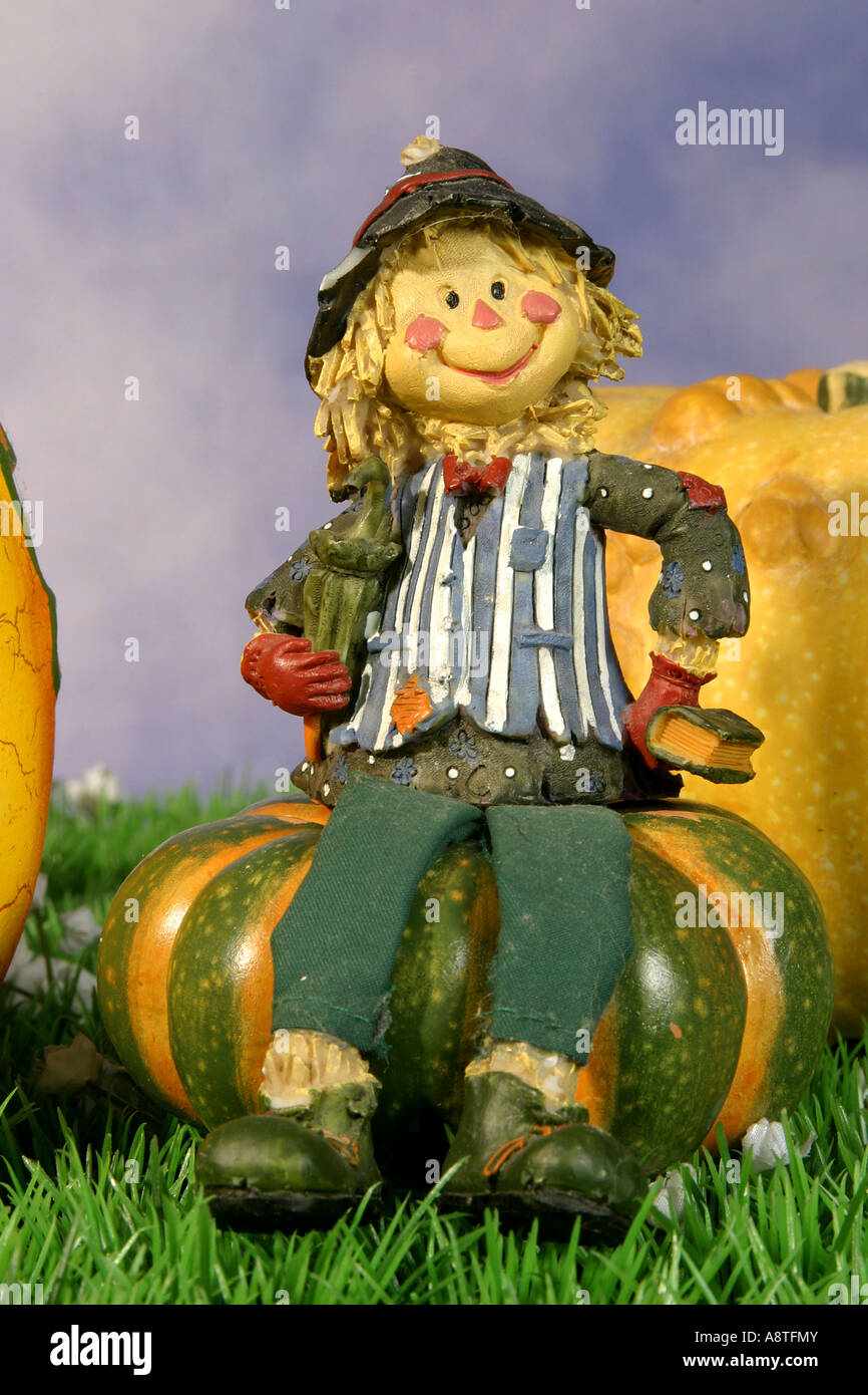straw man sitting on pumpkin Stock Photo - Alamy