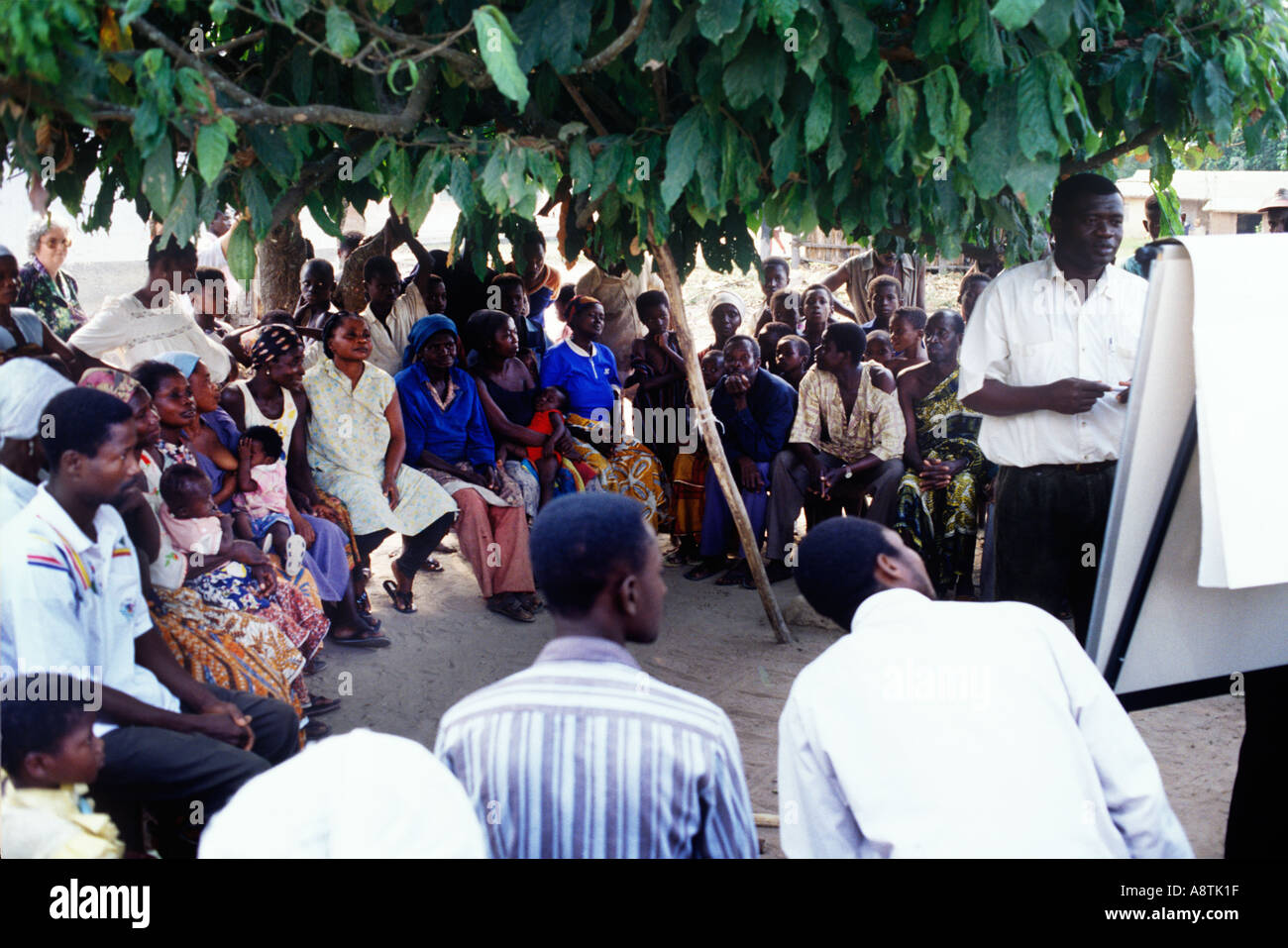 At an open air village meeting in Ghana advisors from the Wenchi ...