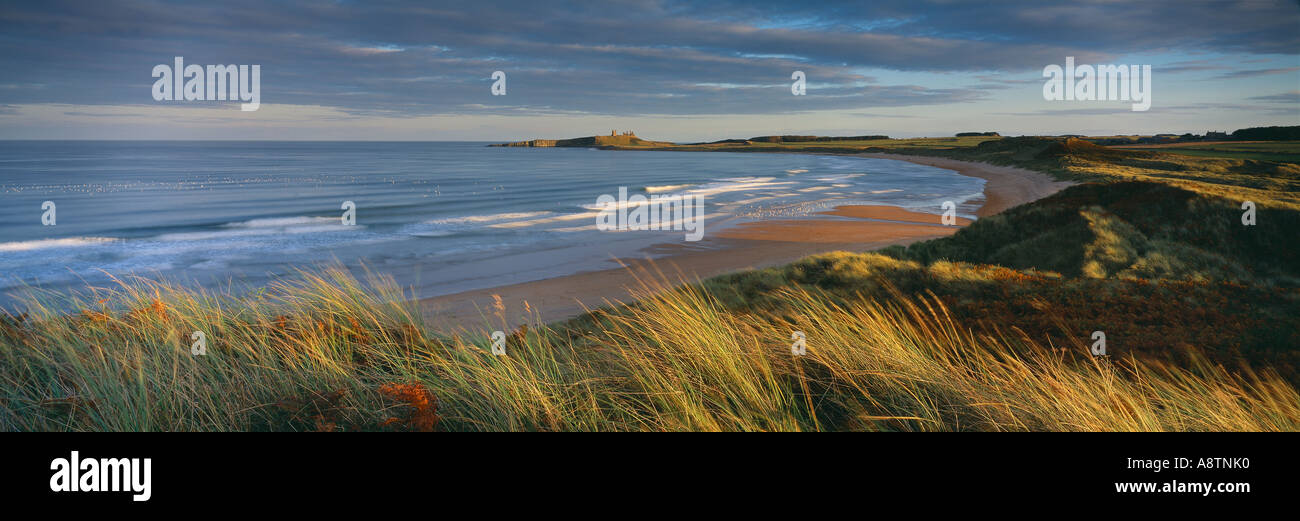 Dunstanburgh Castle Embleton Beach at dusk Northumbria England UK Stock ...