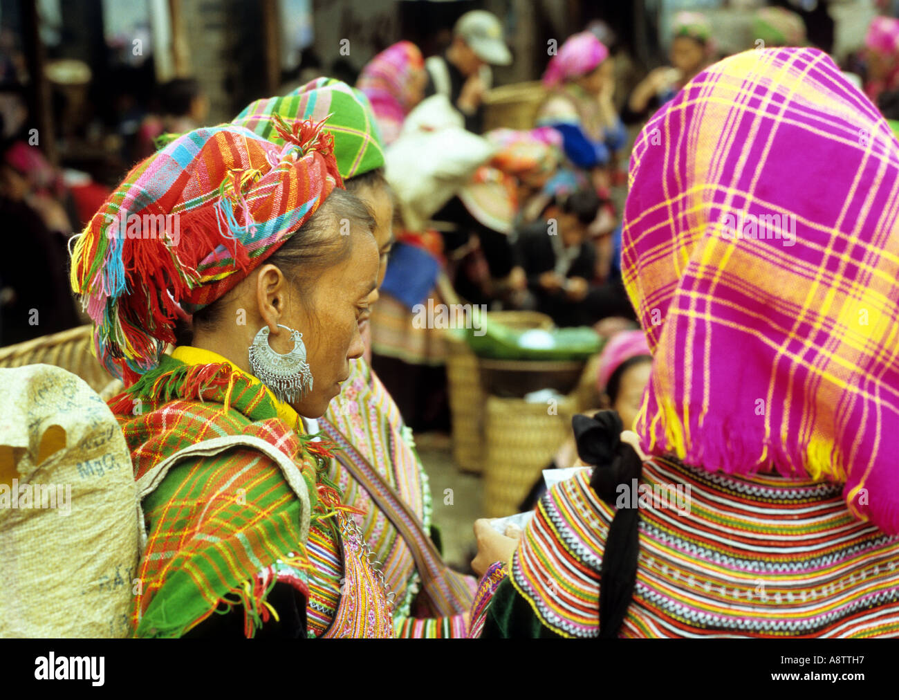 Two Flower Hmong women in colourful traditional clothing at the Sunday ...