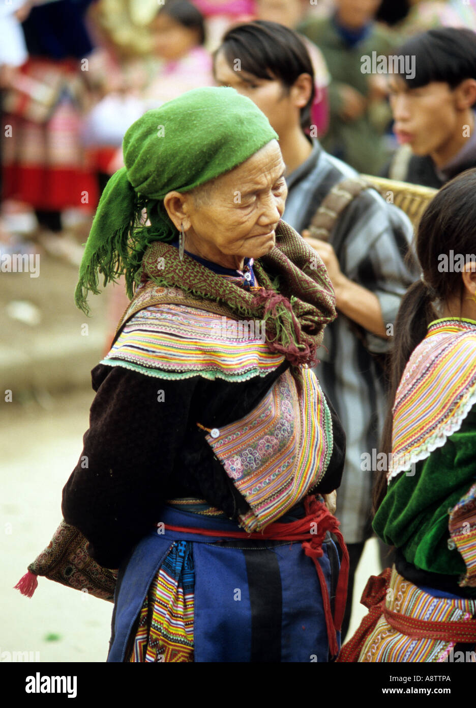 Portrait of traditionally dressed elderly Flower Hmong woman at Sunday ...