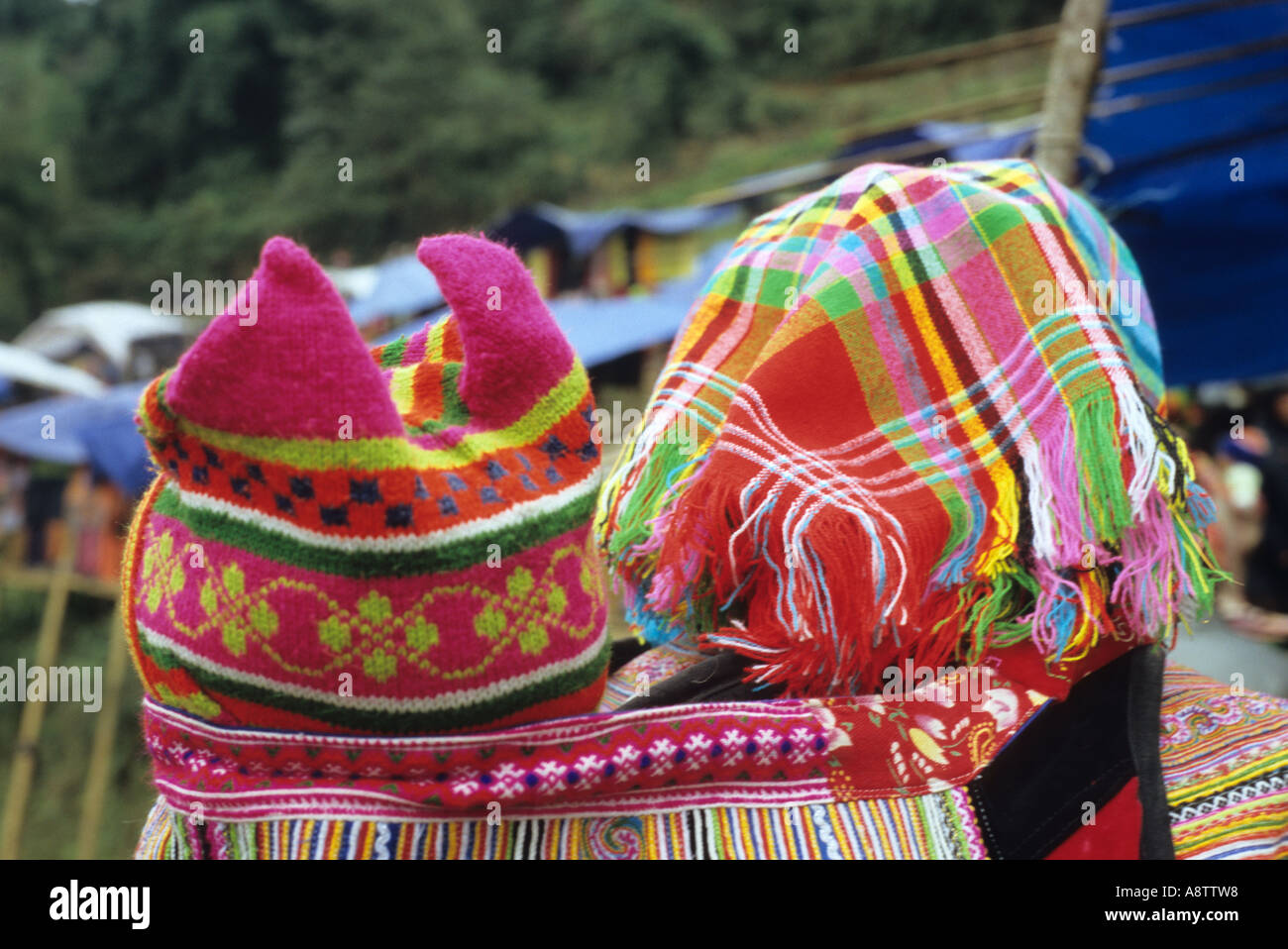 Back view of Flower Hmong woman and her baby, wearing headscarf and hat ...