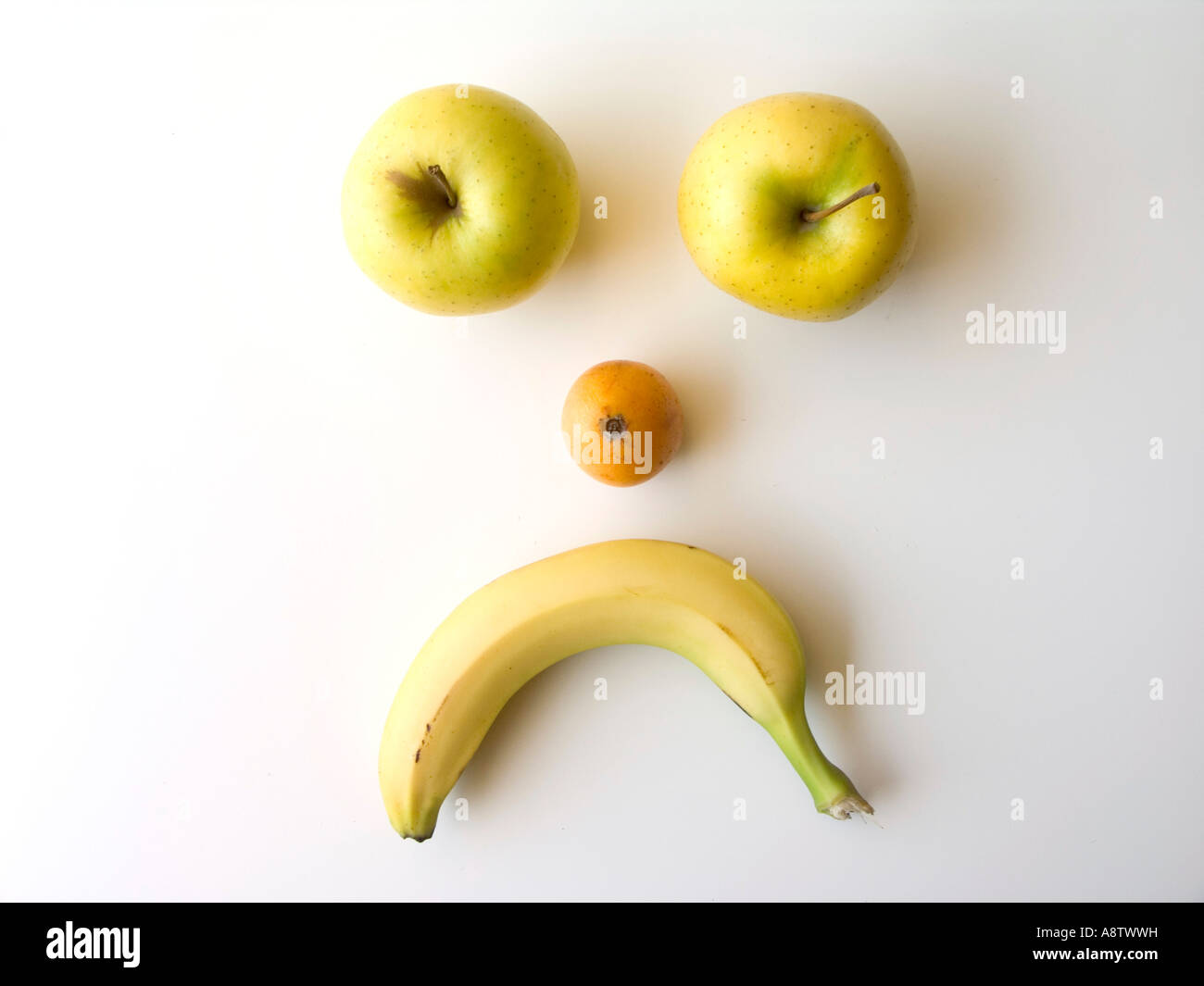 apple apricot and banana composition showing smile sad face Stock Photo ...