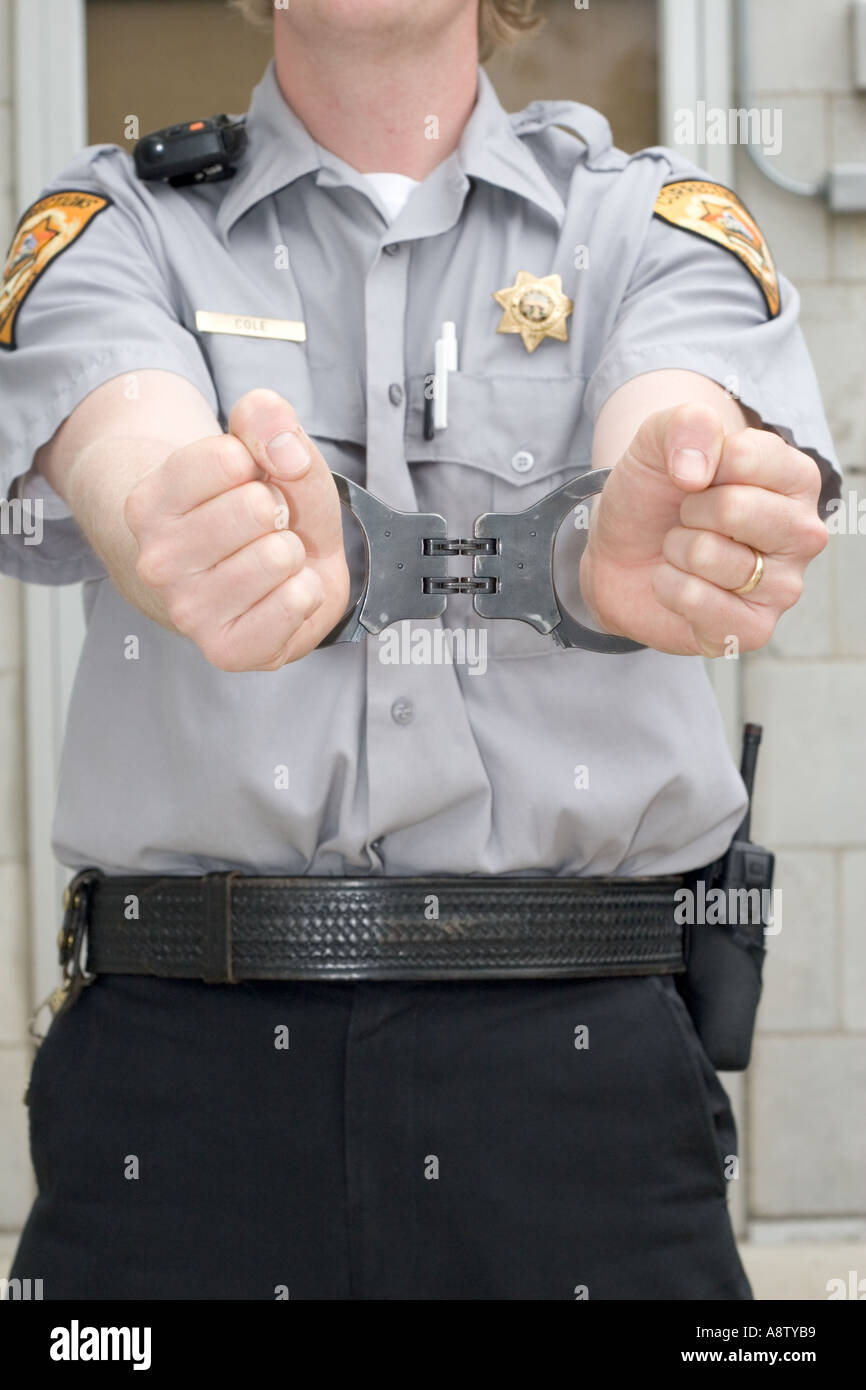 Correctional officer in handcuffs and in uniform Stock Photo - Alamy