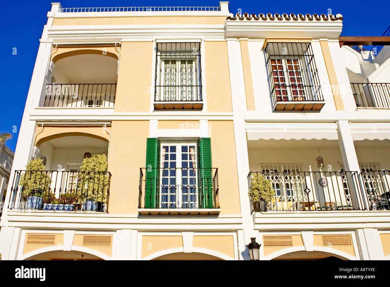 Colourful block of modern townhouses and apartments in Aloha Pueblo on ...