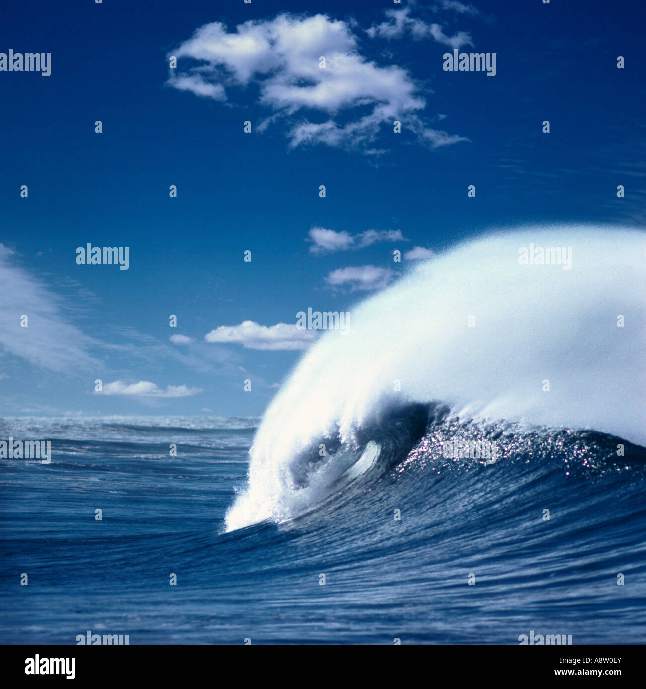 Ocean wave breaking against blue sky Stock Photo - Alamy