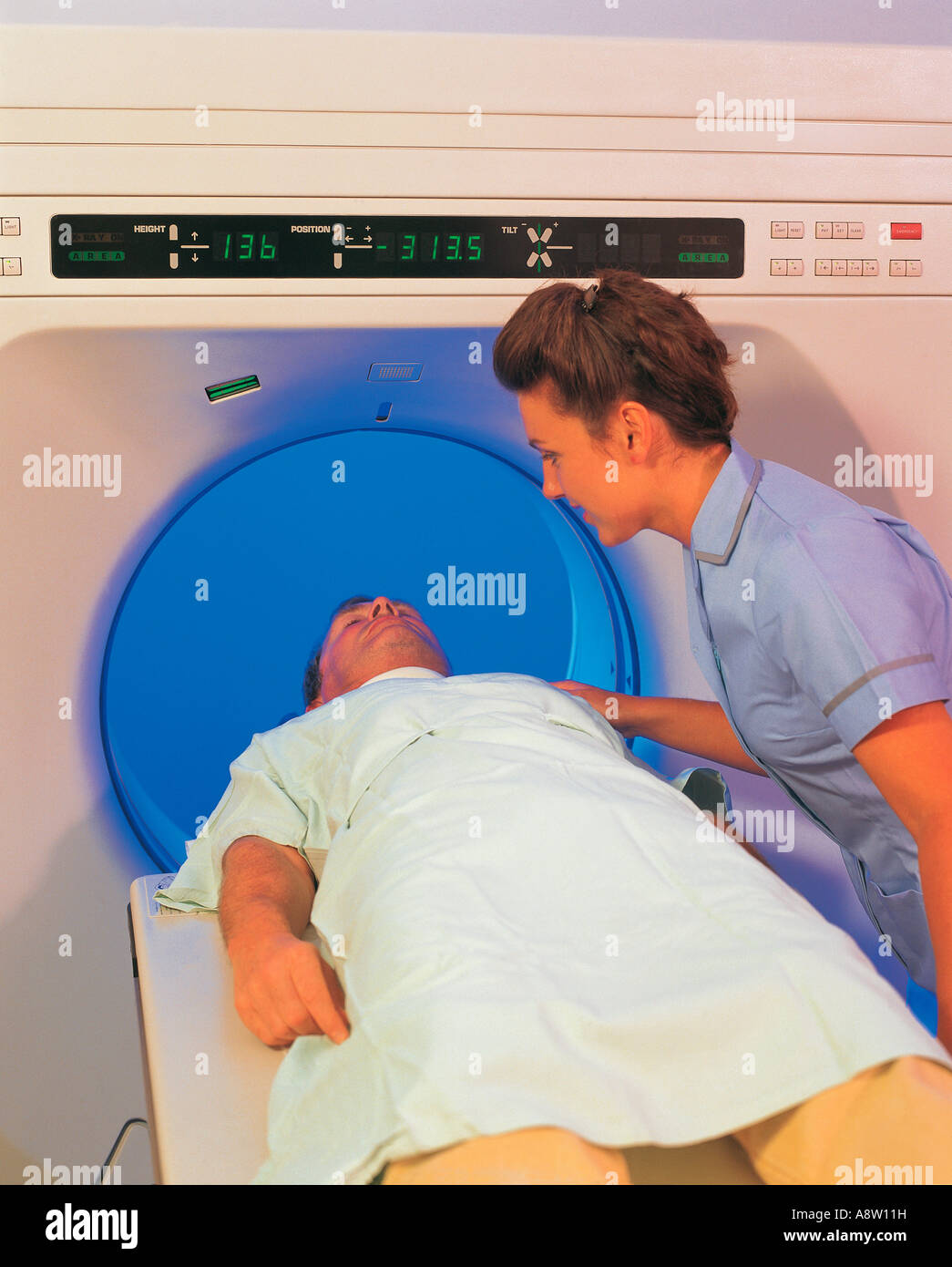 Hospital nurse with male patient undergoing CT Scanning Computed ...