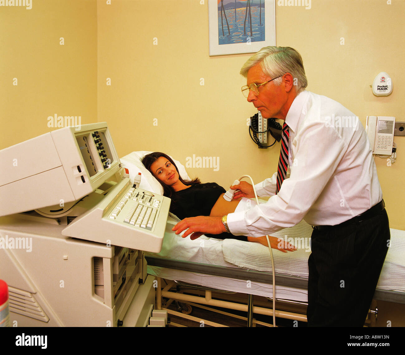 Hospital consultant surgeon conducting ultra sound scanning on young ...