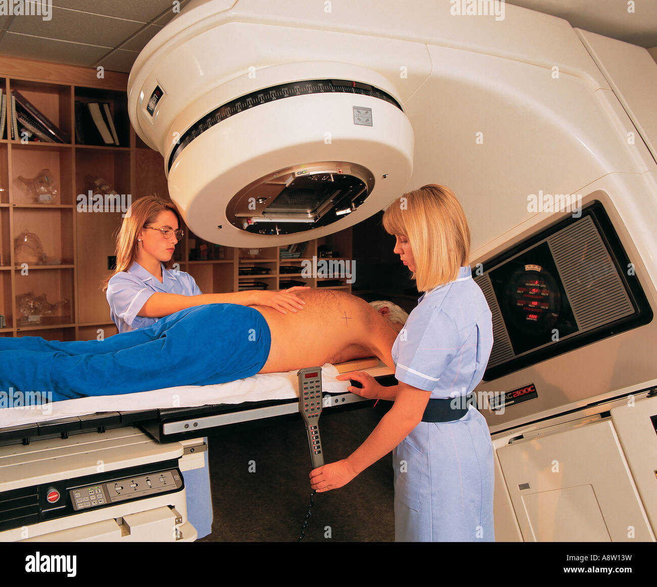 Young woman radiotherapist positioning radiotherapy linear accelerator ...